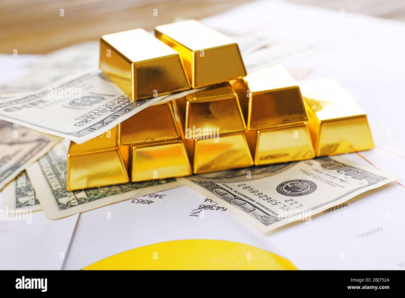Gold bars with dollar banknotes on paper background Stock Photo - Alamy