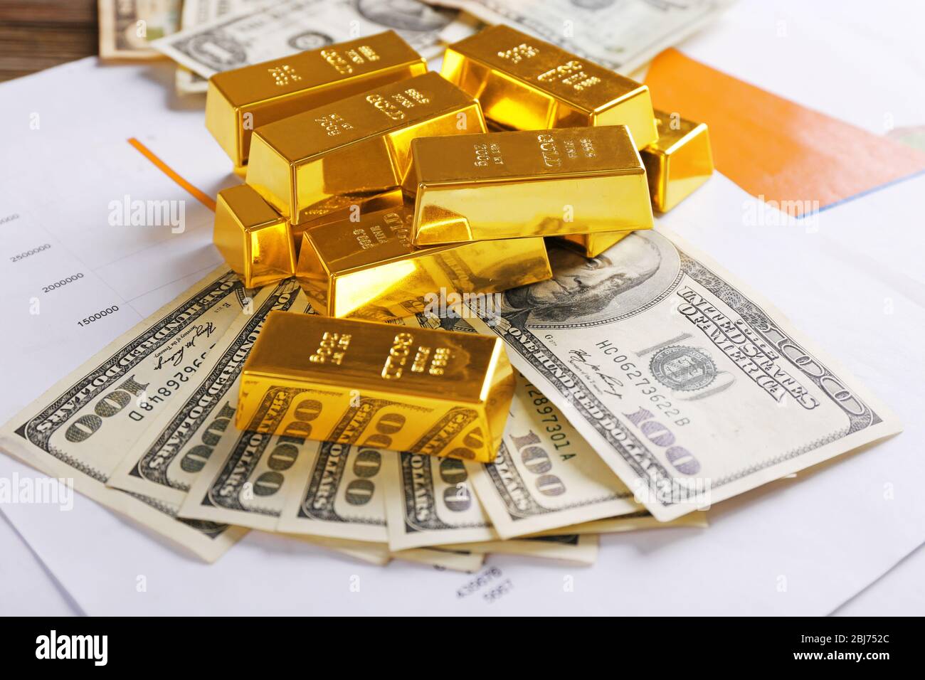 Gold bars with dollar banknotes on paper background Stock Photo - Alamy