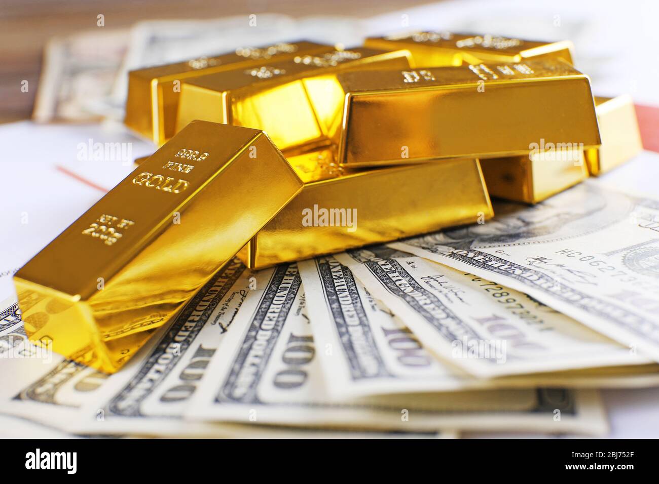 Gold bars with dollar banknotes on paper background Stock Photo - Alamy