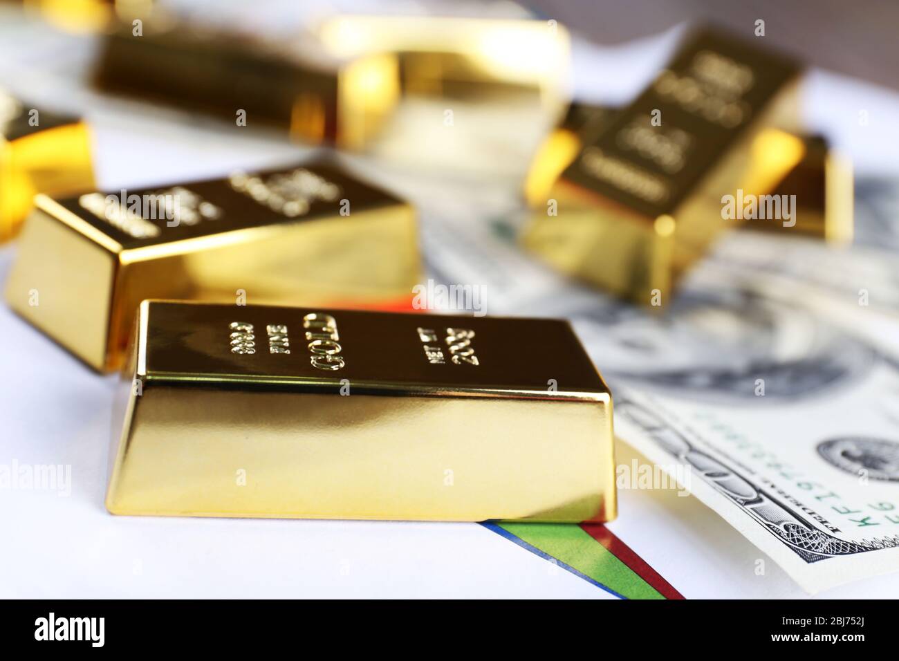 Gold bars with dollar banknote on paper background Stock Photo - Alamy