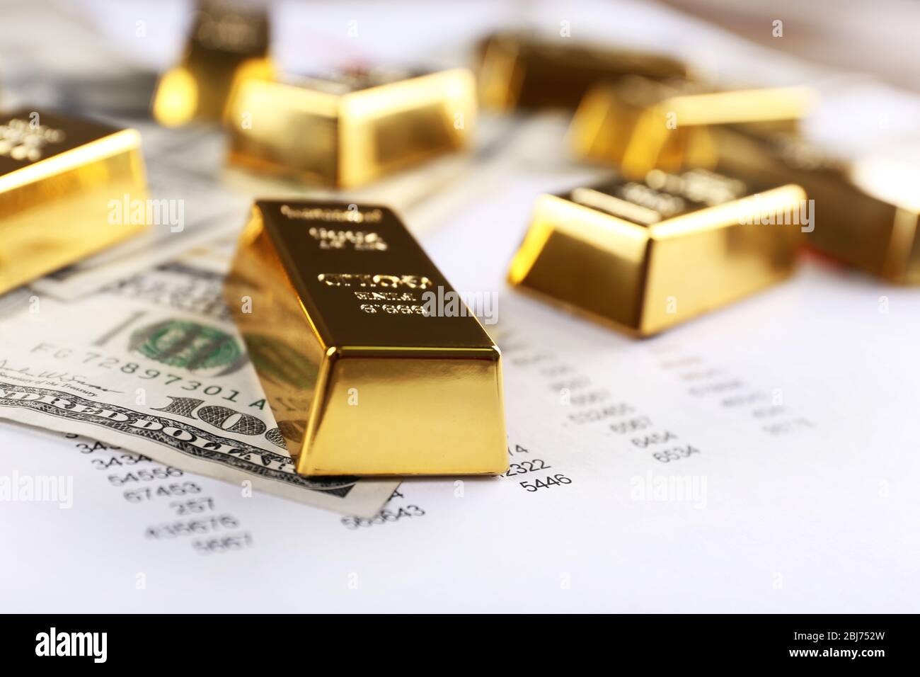 Gold bars with dollar banknotes on paper background Stock Photo - Alamy