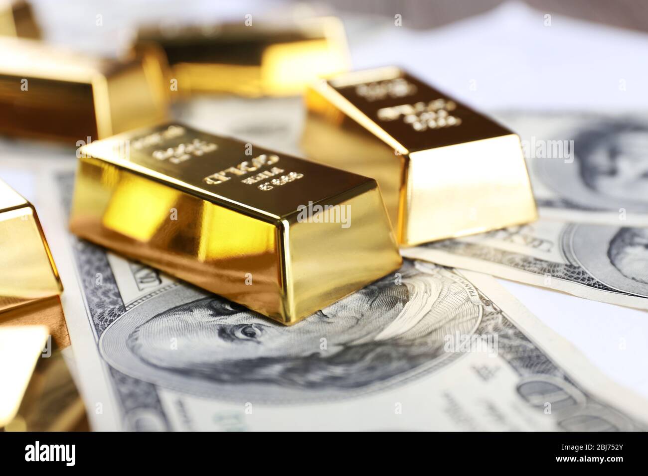 Gold bars with dollar banknotes on paper background Stock Photo - Alamy