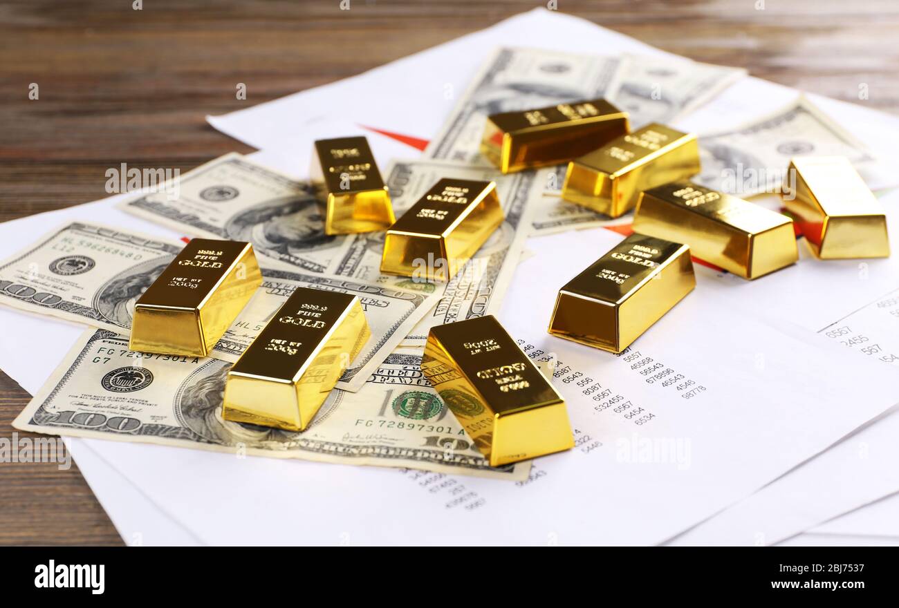 Gold bars with dollar banknotes on paper background Stock Photo - Alamy