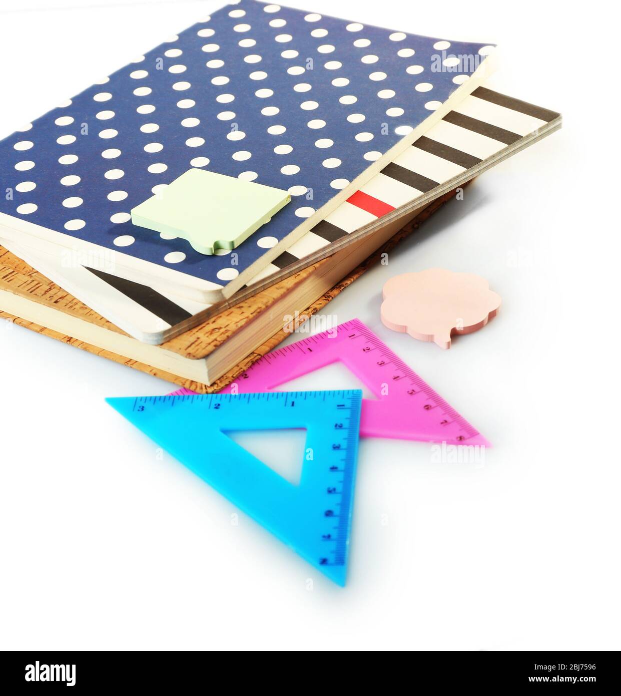 A pile of stylish notebooks and stationary, isolated on white ...