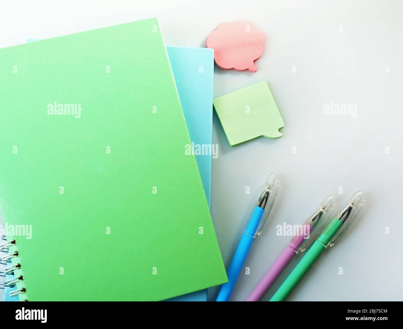 A pile of notebooks and stationary, isolated on white background Stock ...