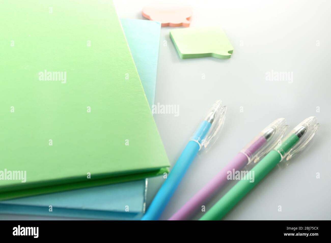 A pile of notebooks and stationary, isolated on white background Stock ...