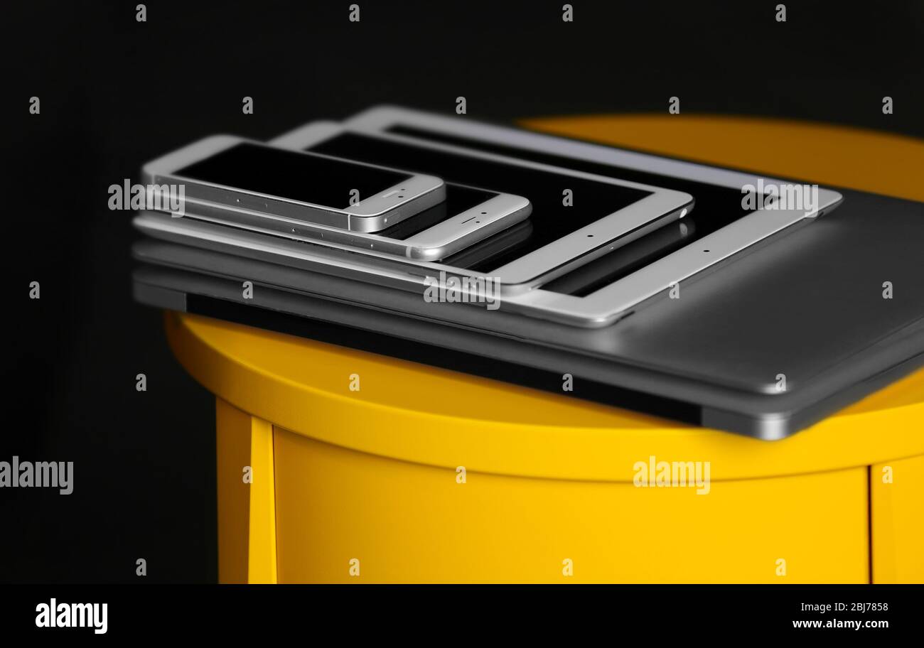 Pile of electronic gadgets on the table. Communication and technology ...