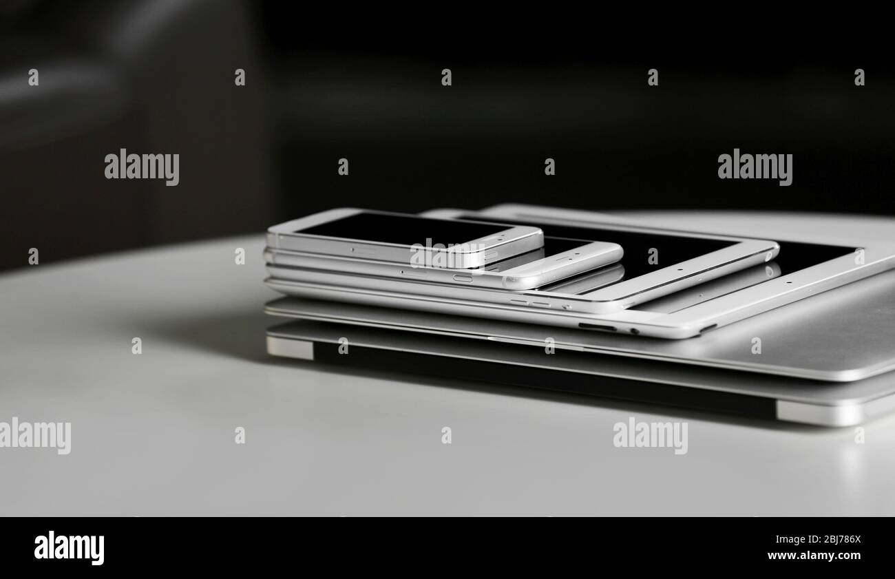 Pile of electronic gadgets on the table. Communication and technology ...