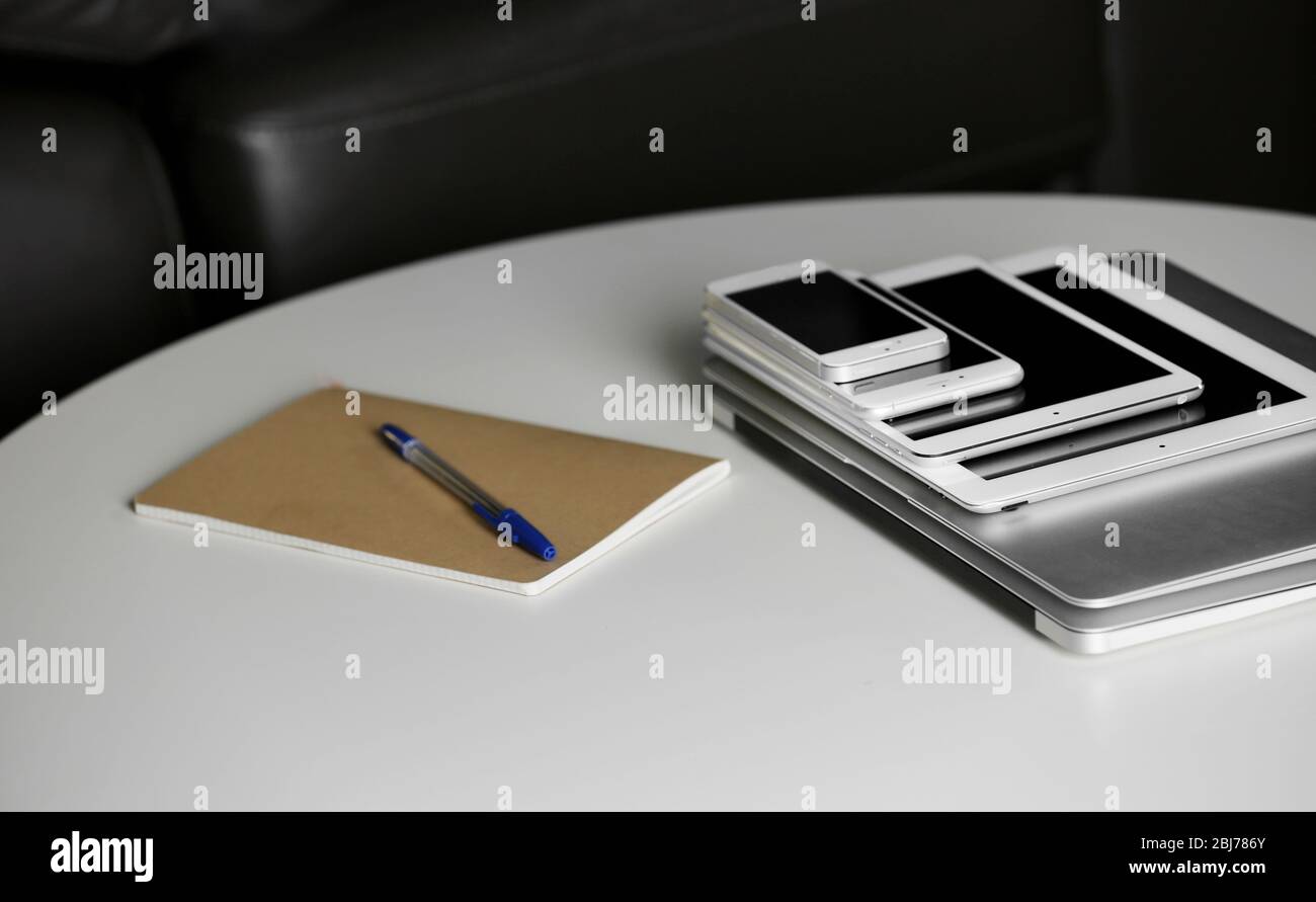 Pile of electronic gadgets on the table. Communication and technology ...