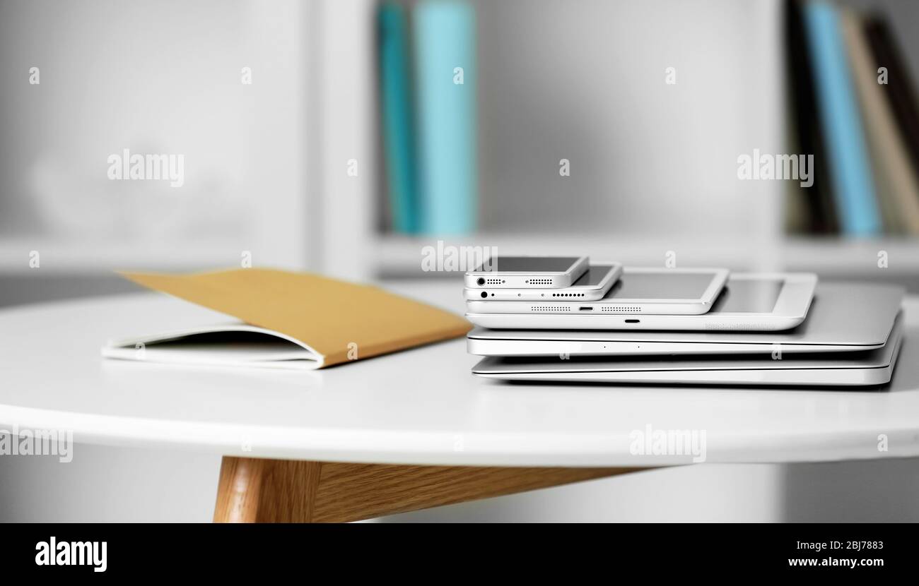 Pile of electronic gadgets on the table. Communication and technology ...