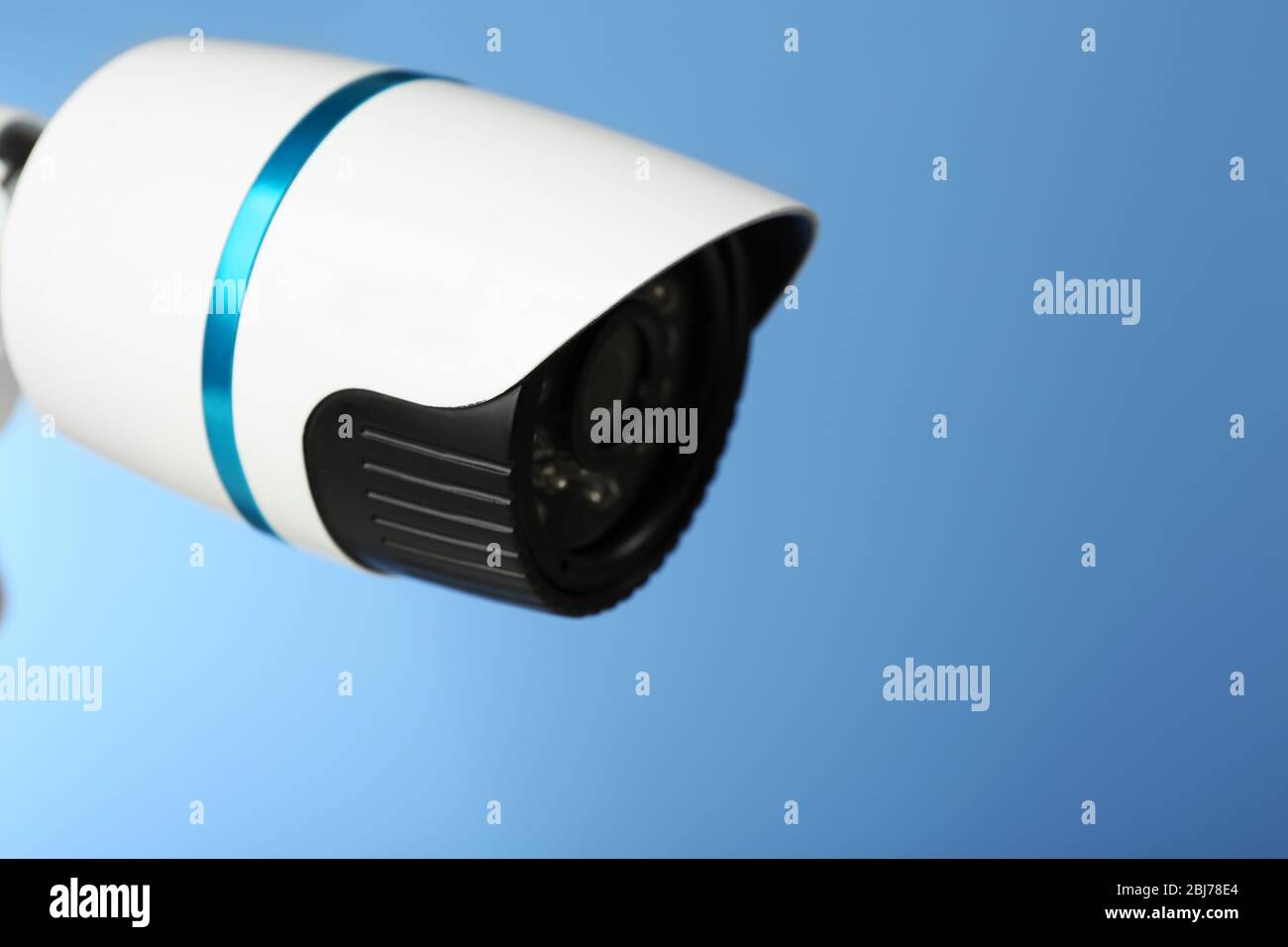Security CCTV camera on blue background, closeup Stock Photo - Alamy