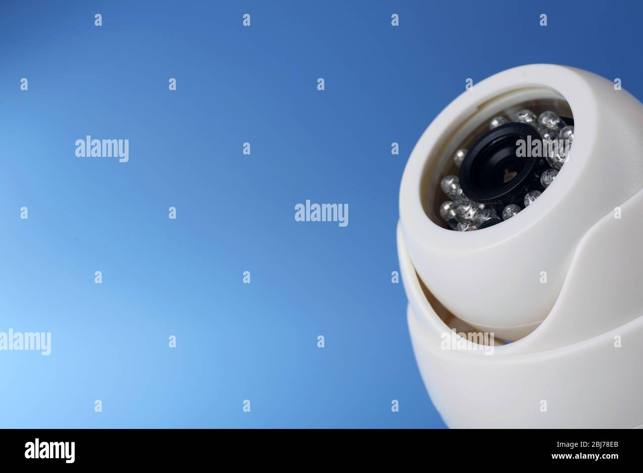 Security CCTV camera on blue background, closeup Stock Photo - Alamy
