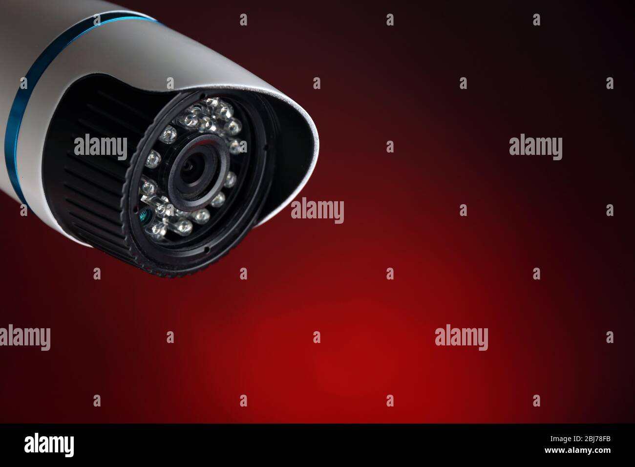 Security CCTV camera on red background, closeup Stock Photo - Alamy