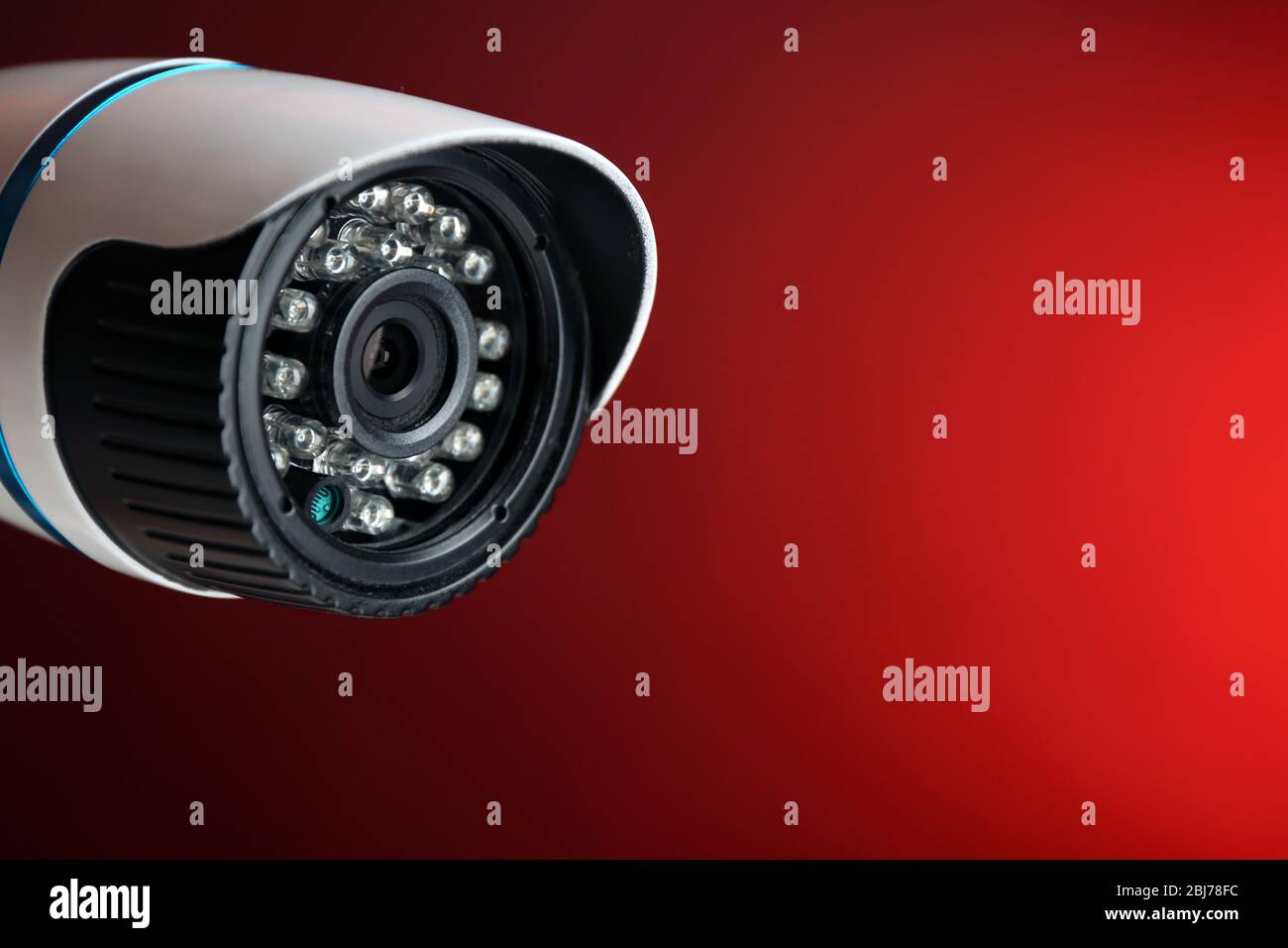 Security CCTV camera on red background, closeup Stock Photo - Alamy