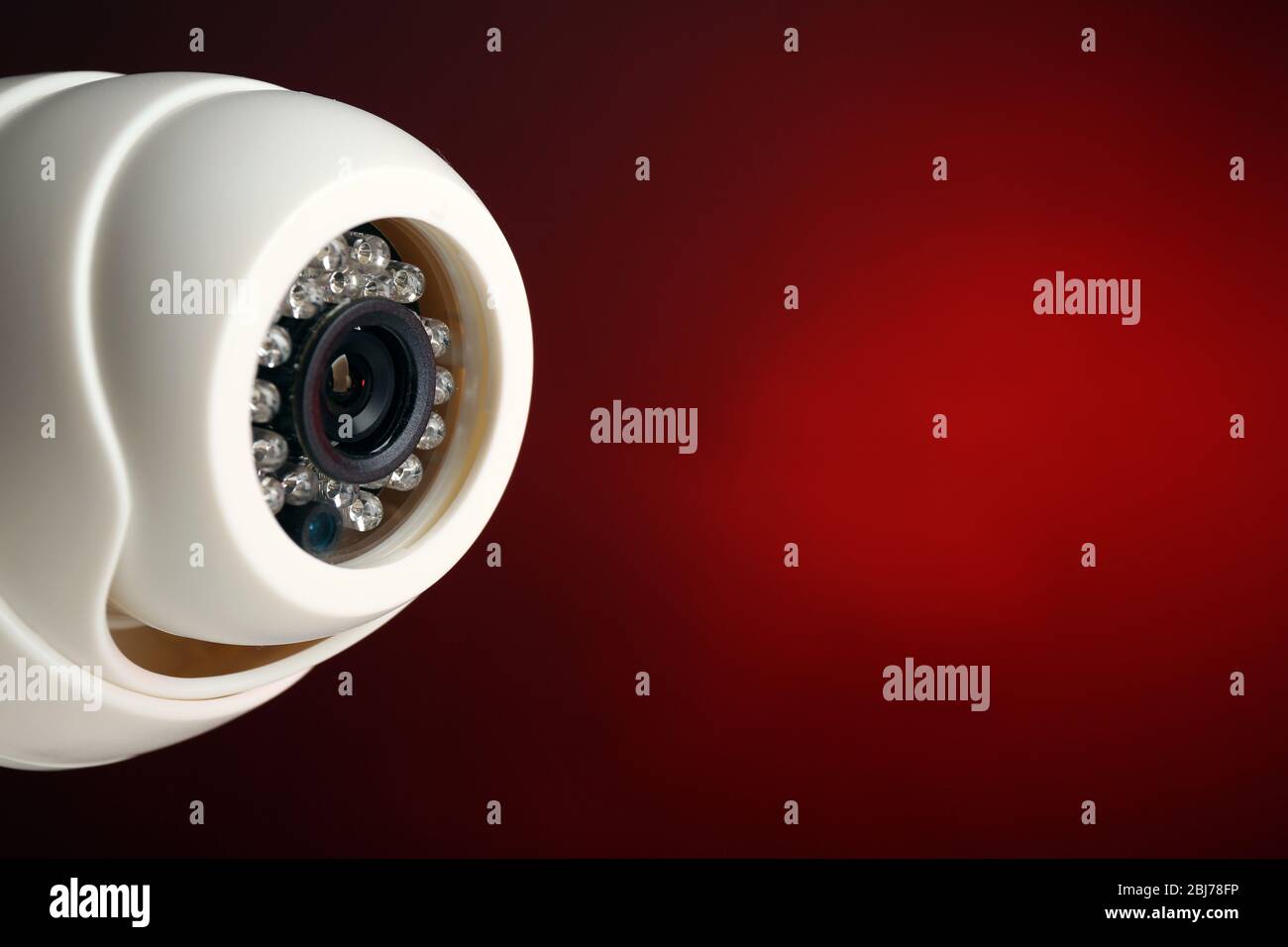 Security CCTV camera on red background, closeup Stock Photo - Alamy