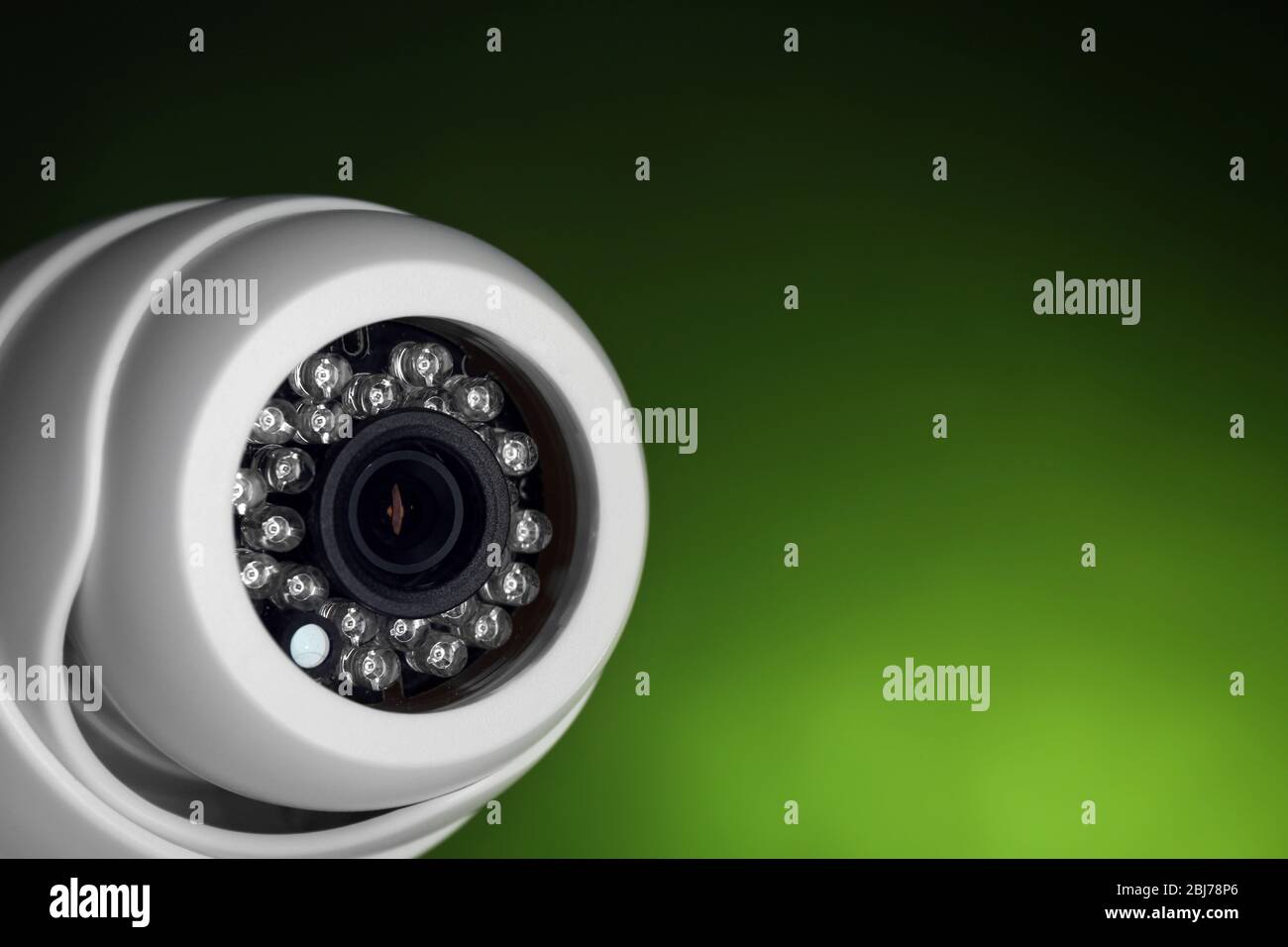 Security CCTV camera on green background, closeup Stock Photo - Alamy