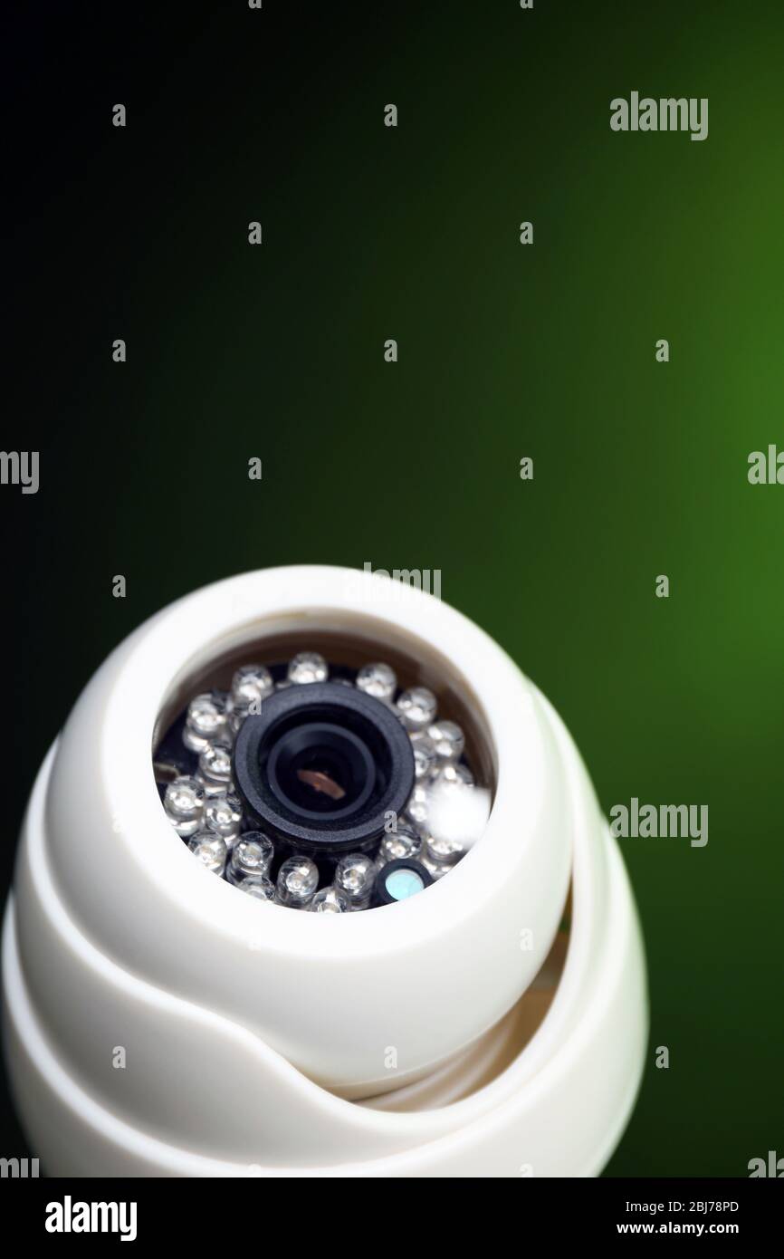 Security CCTV camera on green background, closeup Stock Photo - Alamy