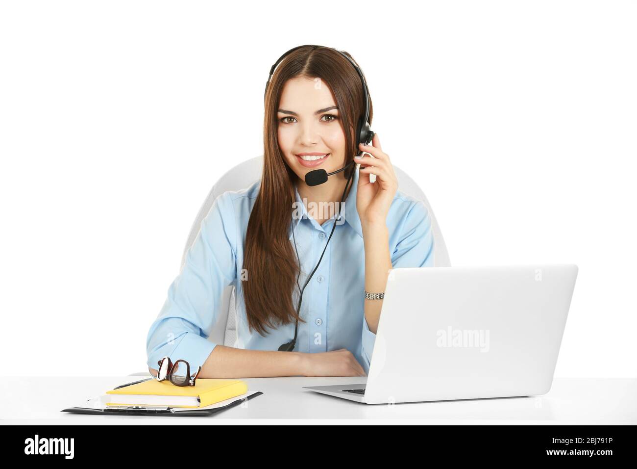 A beautiful woman with headphones and microphone working at the office ...