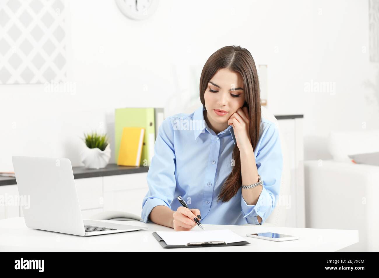 A beautiful successful woman working at the modern office Stock Photo ...
