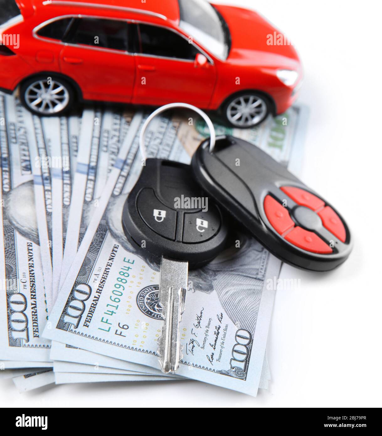 New red car with keys and dollar banknotes on white background Stock ...