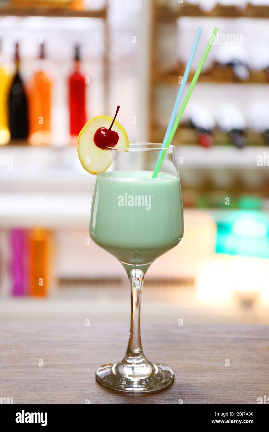 Glass of cocktail on bar background Stock Photo - Alamy