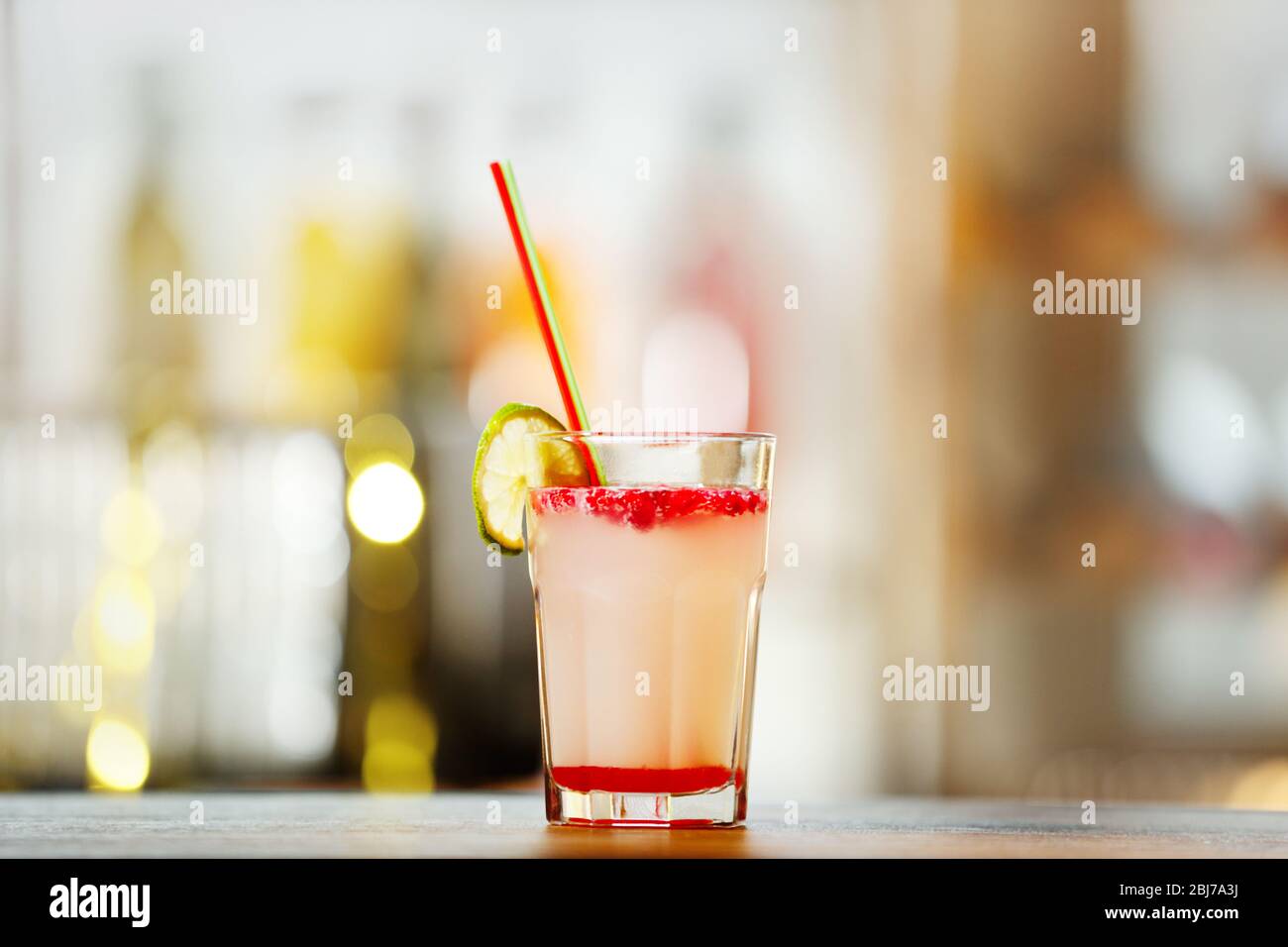 Glass of cocktail on bar background Stock Photo - Alamy
