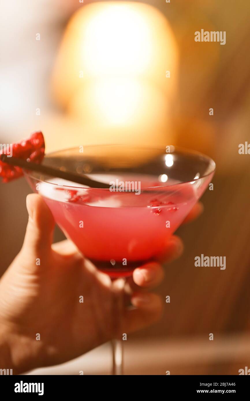 Female hand with glass of cocktail on bar background Stock Photo - Alamy