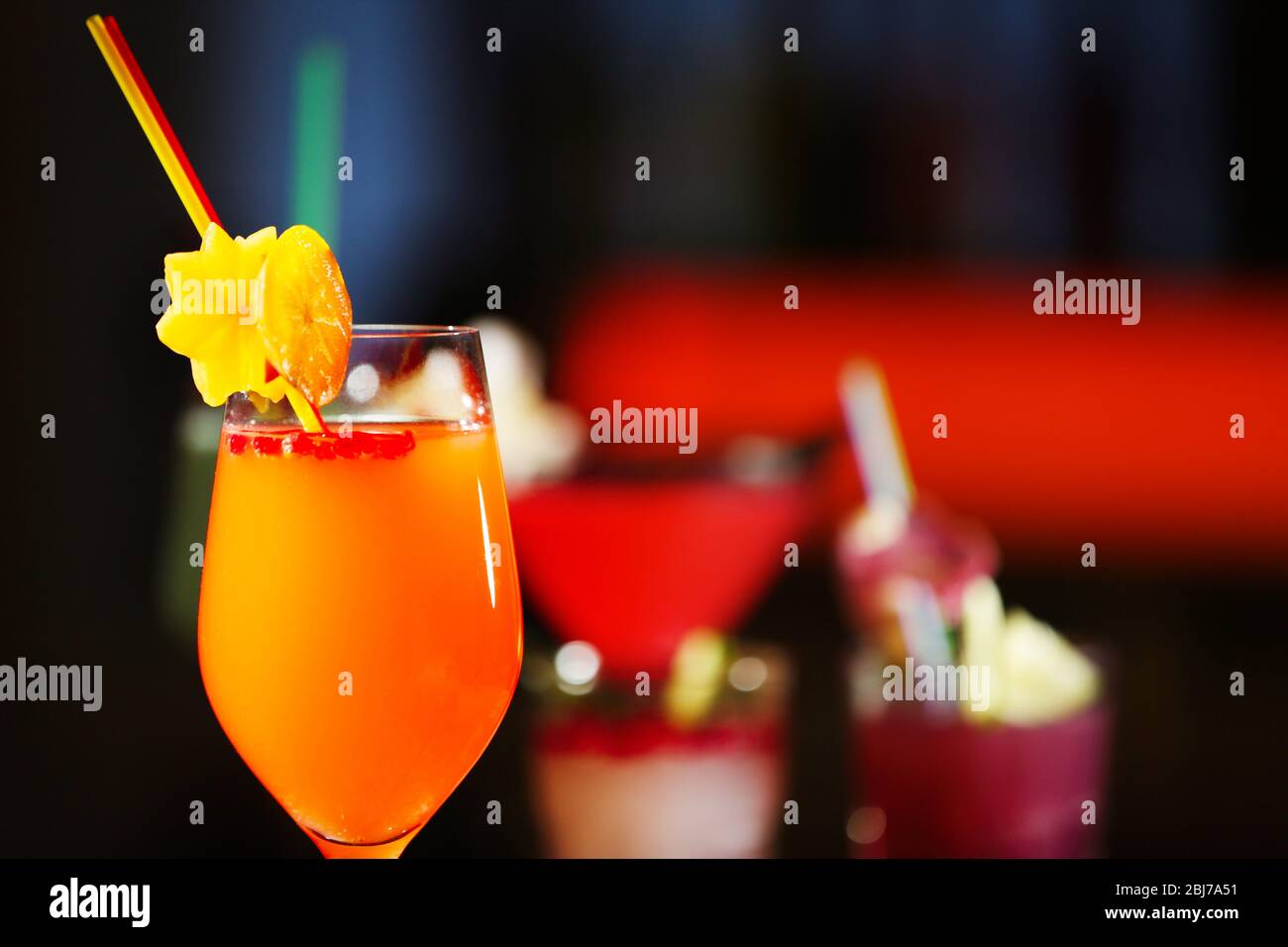 Glasses of cocktails on bar background Stock Photo - Alamy