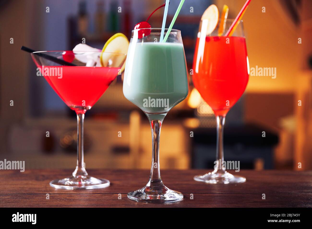Glasses of cocktails on bar background Stock Photo - Alamy