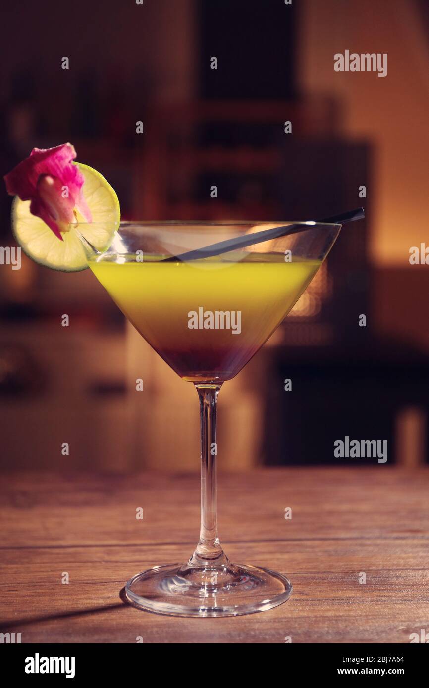 Glass of cocktail on bar background Stock Photo - Alamy