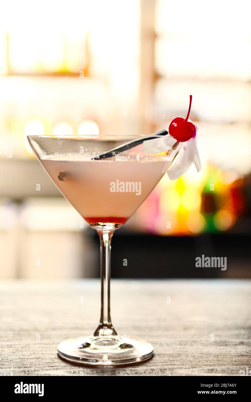 Glass of cocktail on bar background Stock Photo - Alamy