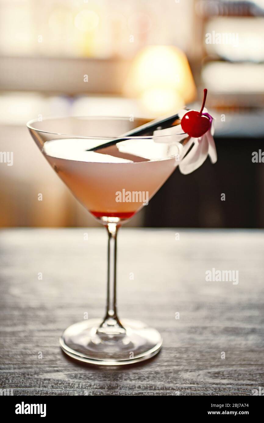 Glass of cocktail on bar background Stock Photo - Alamy