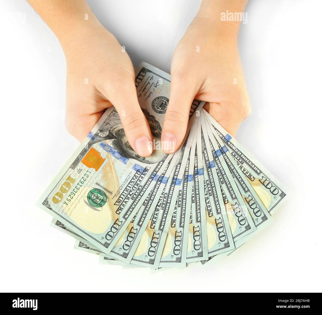 Fan of money in female hands isolated on white Stock Photo - Alamy