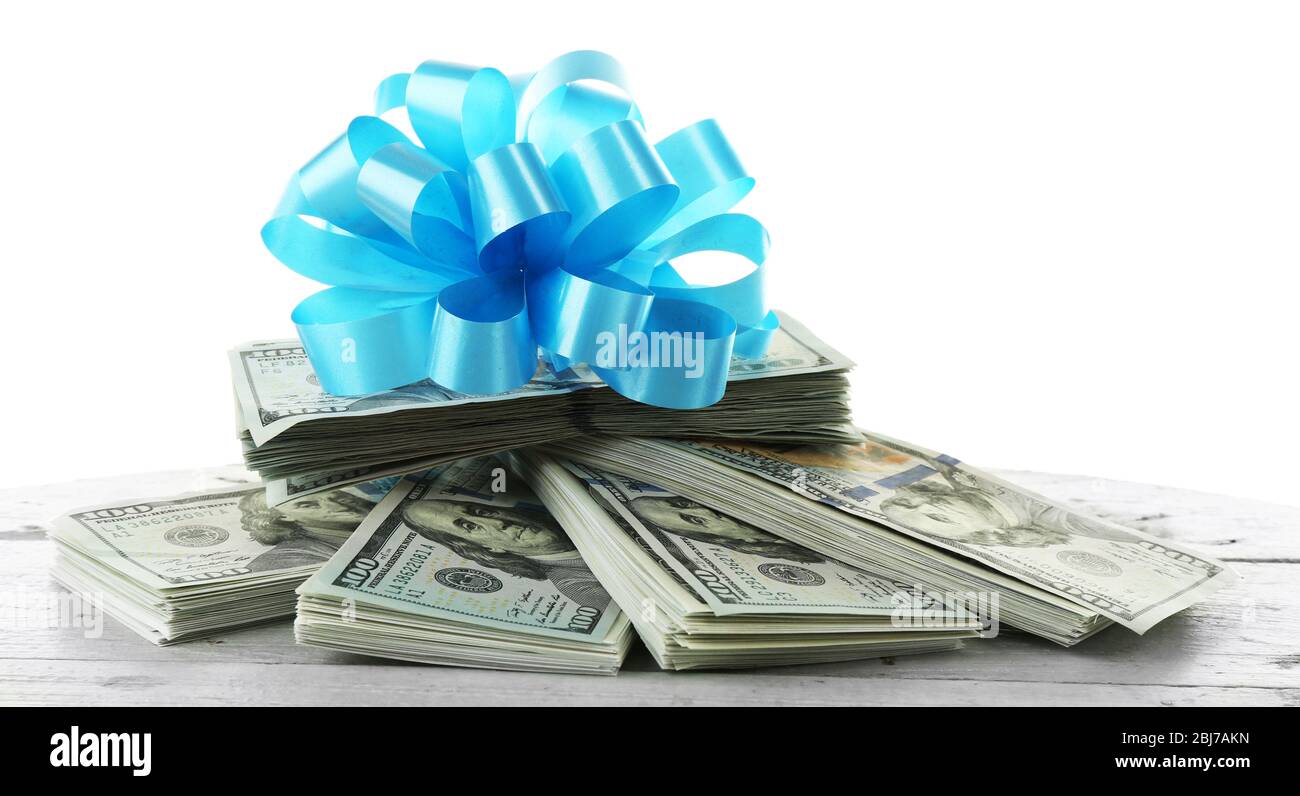 Pile of dollars with bow as gift isolated on white Stock Photo - Alamy