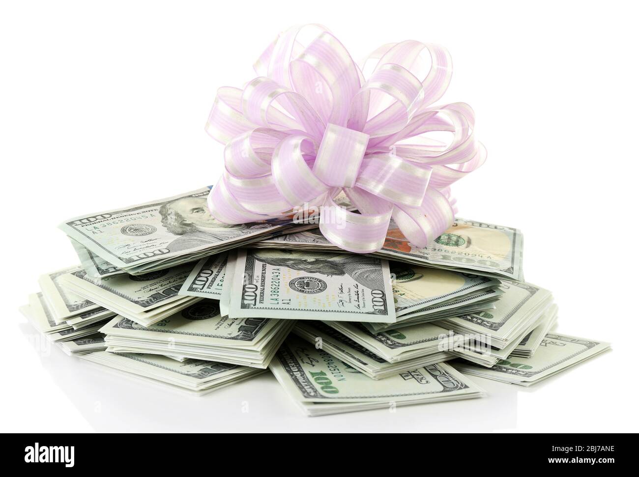Pile of dollars with bow as gift isolated on white Stock Photo - Alamy
