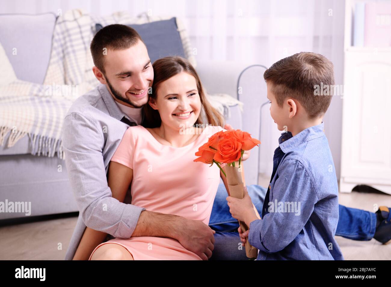 Son giving roses to his mother Stock Photo - Alamy