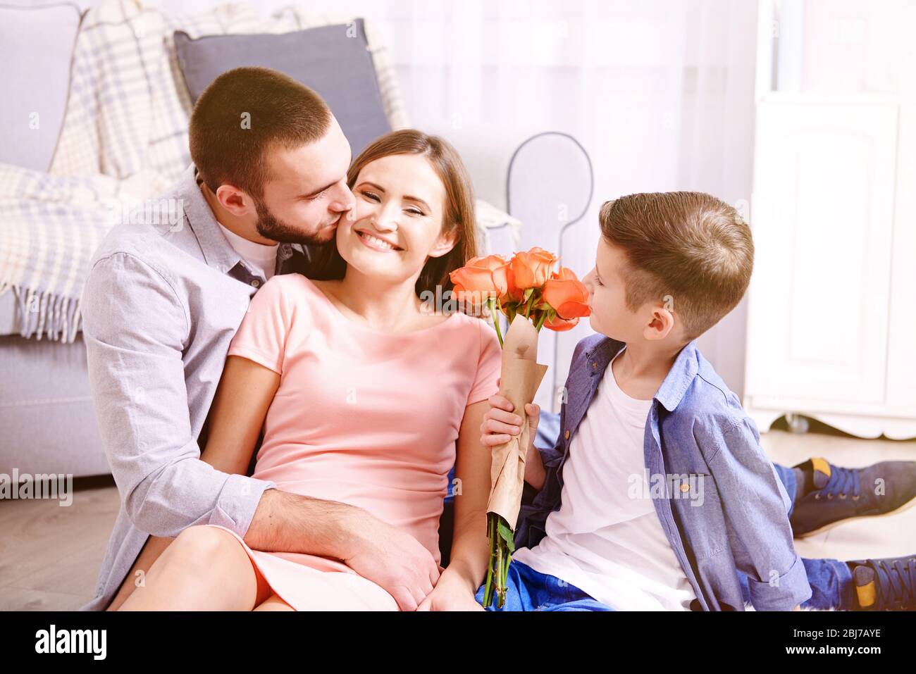 Son giving roses to his mother Stock Photo - Alamy