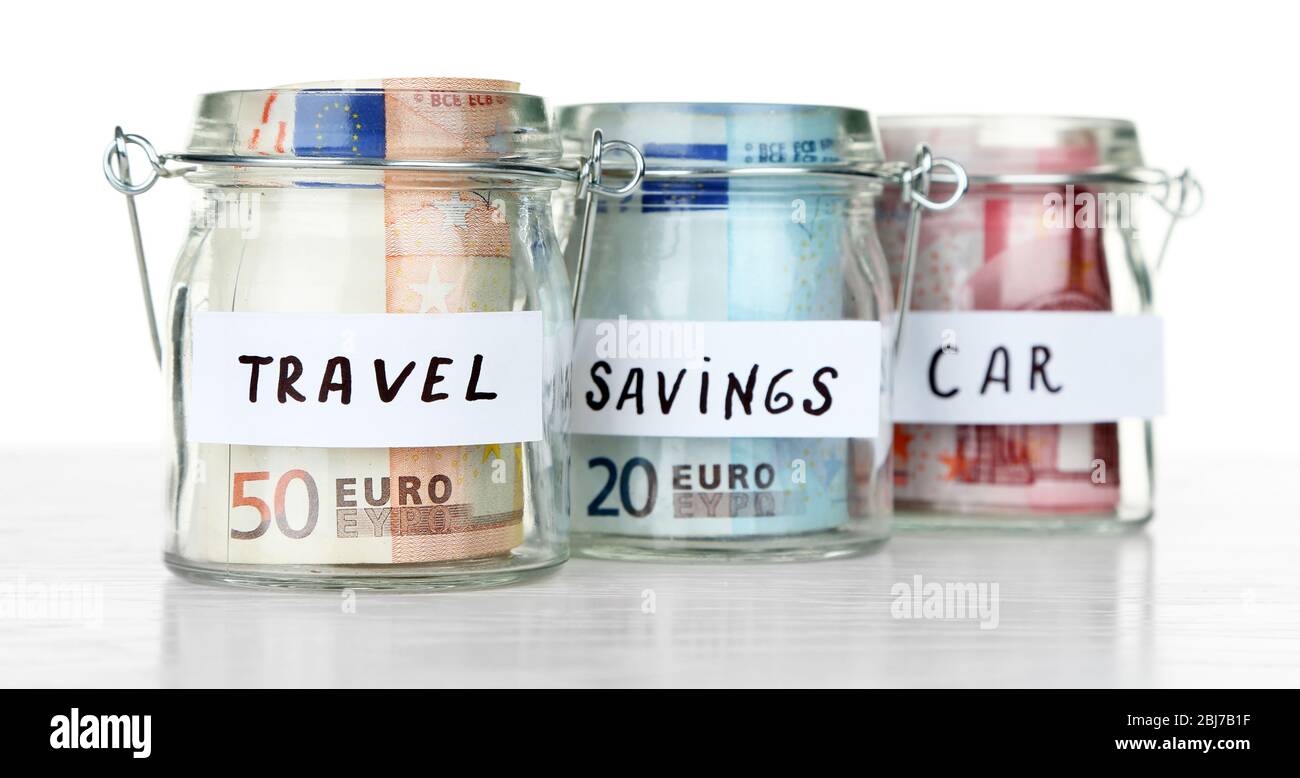 Three jars for different needs full of coins Stock Photo - Alamy