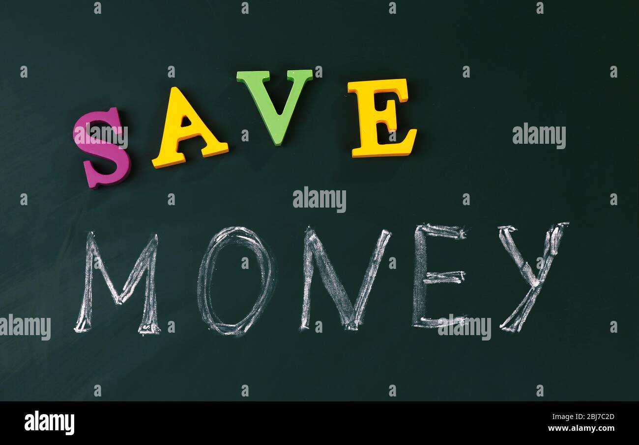 Save money concept on a blackboard background Stock Photo - Alamy