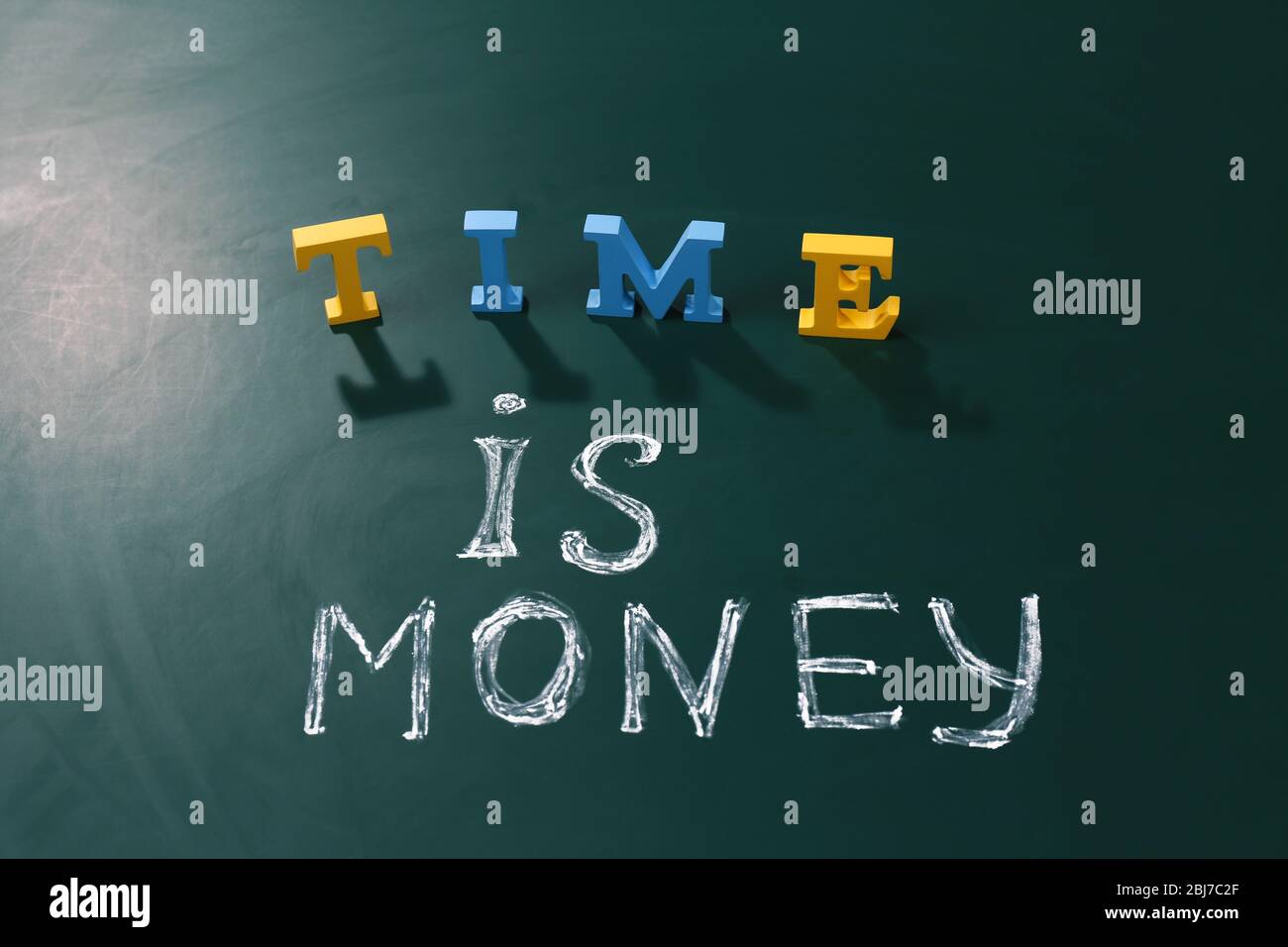 Time is money concept on a blackboard background Stock Photo - Alamy
