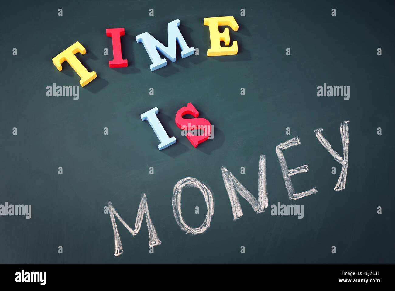 Time is money concept on a blackboard background Stock Photo - Alamy