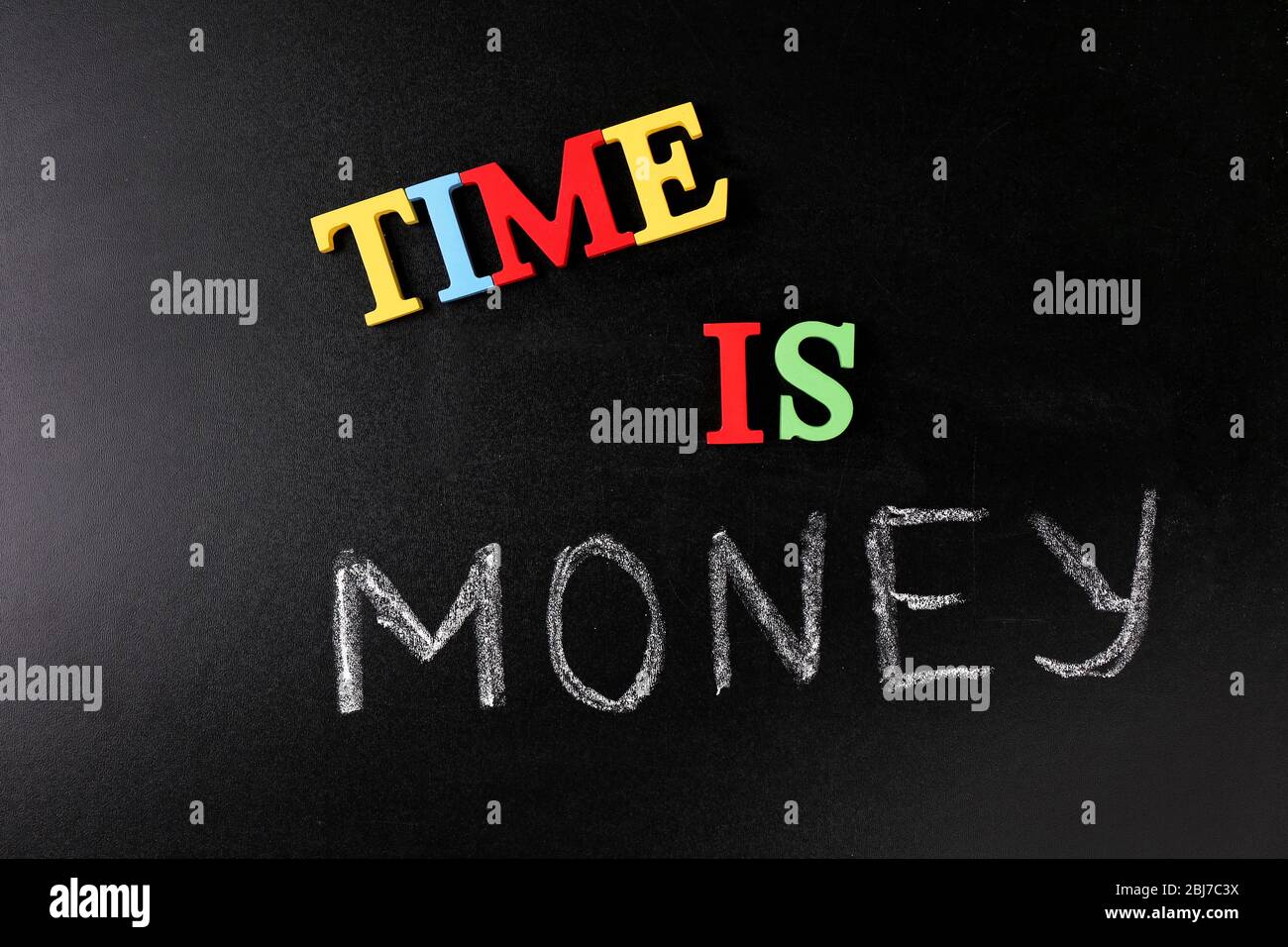 Time is money concept on a blackboard background Stock Photo - Alamy