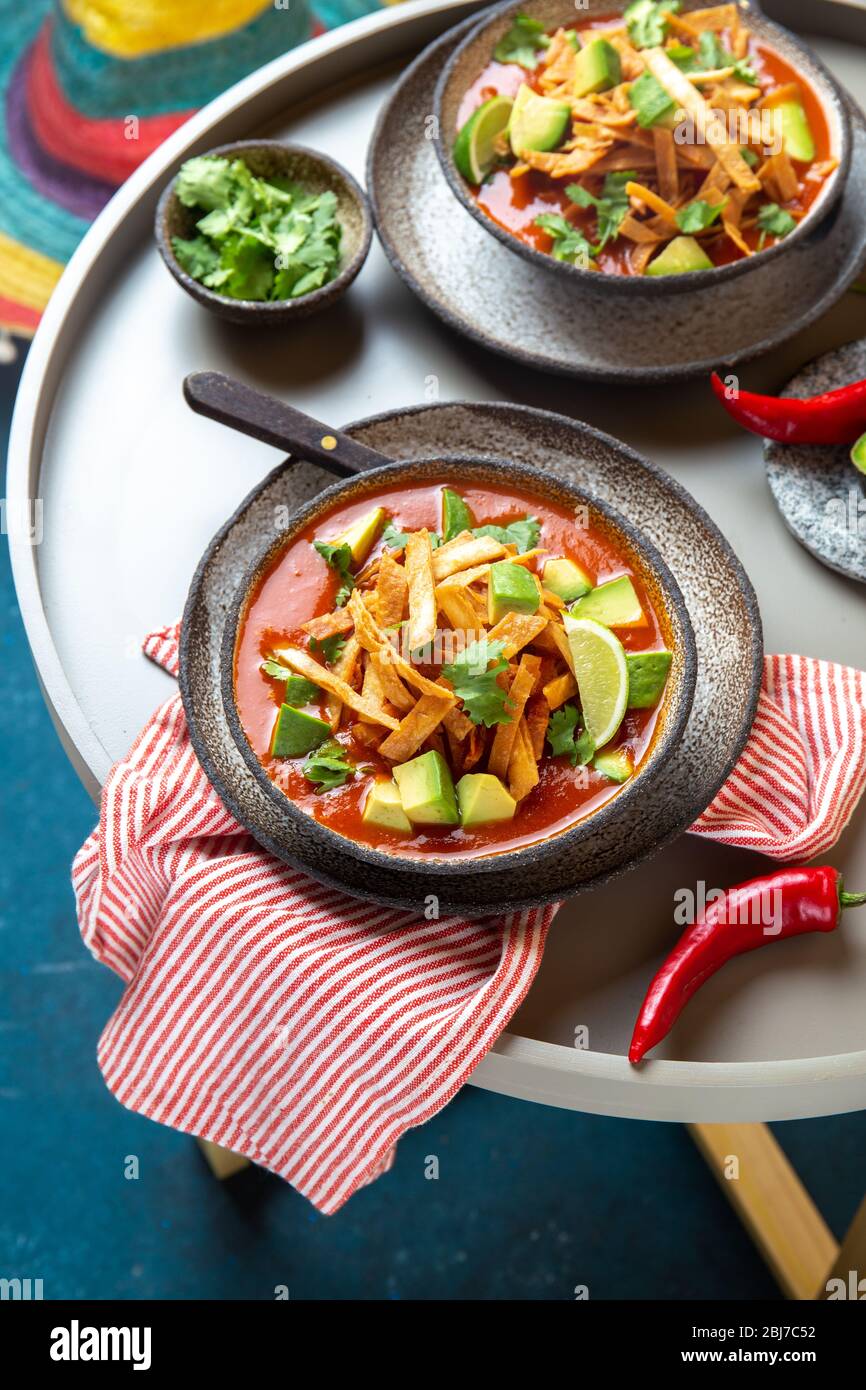 Mexican style table with spicy aztec soup with fried tortilla. Sopa ...