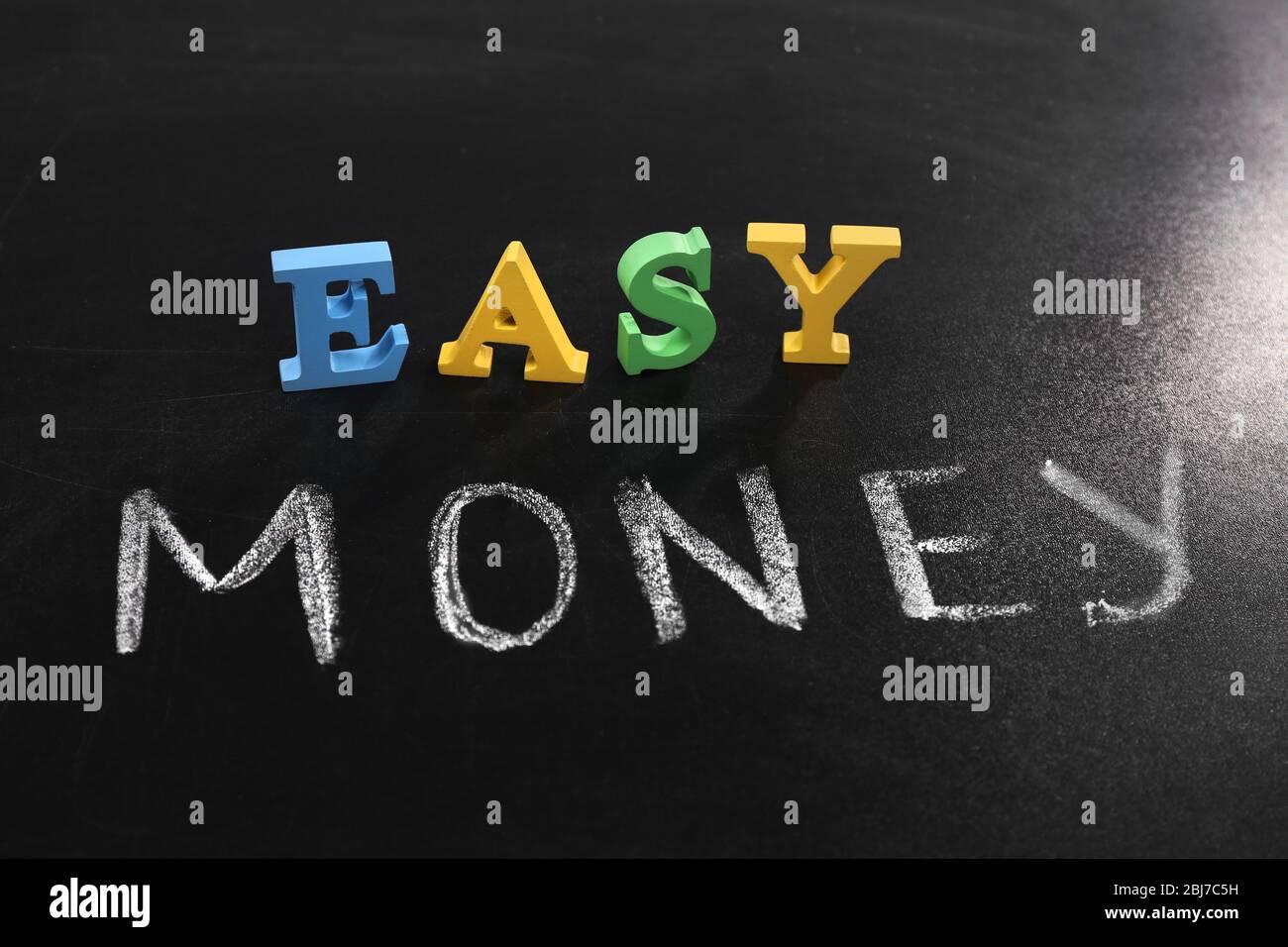 Easy money concept on a blackboard background Stock Photo - Alamy