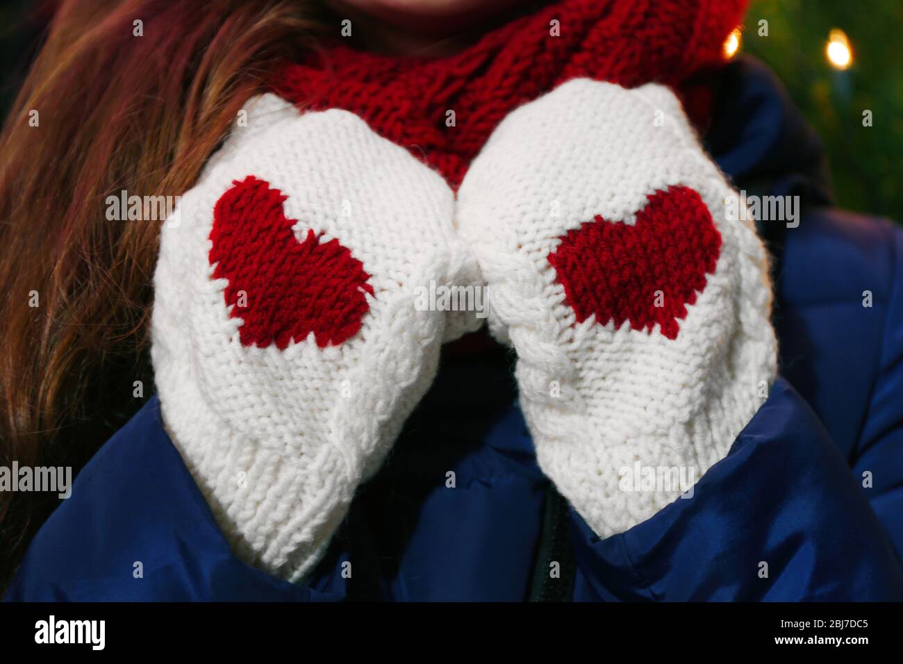 Female hands in warm white gloves with red heart Stock Photo - Alamy