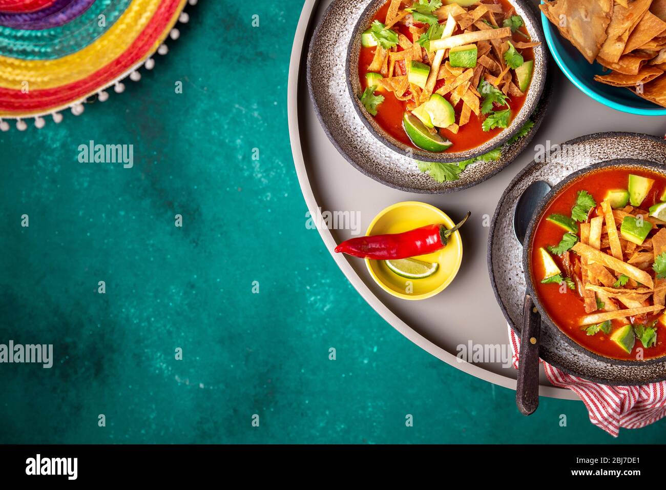 Mexican style table with spicy aztec soup with tortilla. Copy space ...