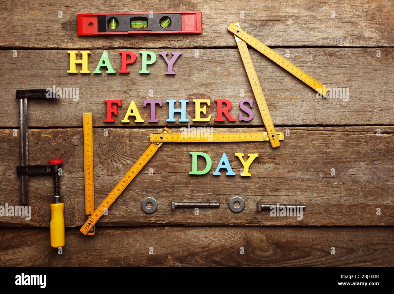 Happy Father's Day inscription with work tools on wooden background ...