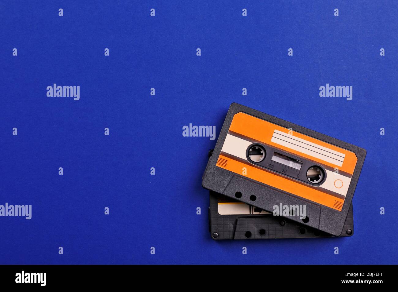Old audio cassettes on blue background Stock Photo - Alamy