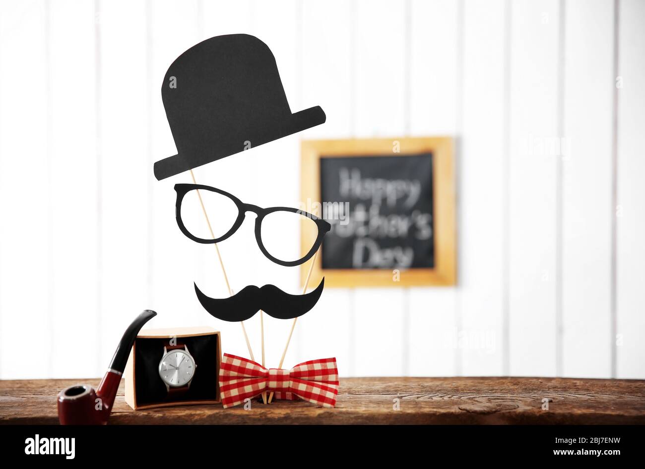 Happy Father's Day inscription at blackboard with bow tie, pipe and ...