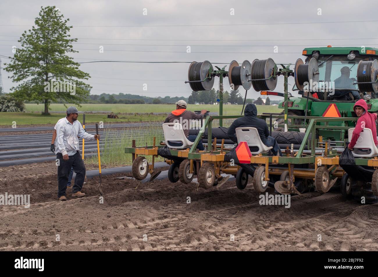 Agriculture workers on farm machinery ready to plant a field Stock ...